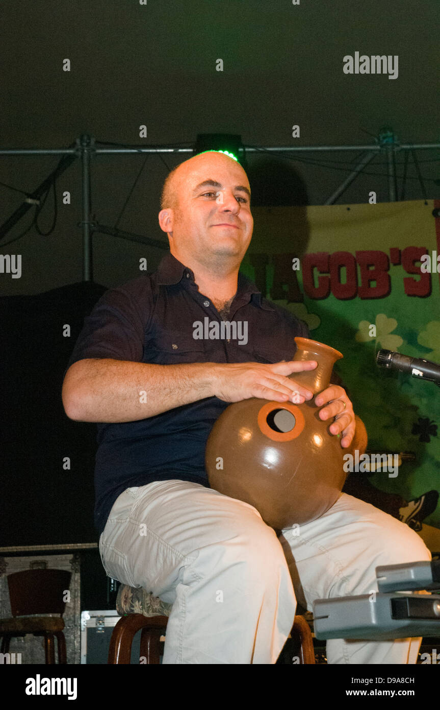 Musician plays a clay percussion instrument known in India as a Ghatam ...