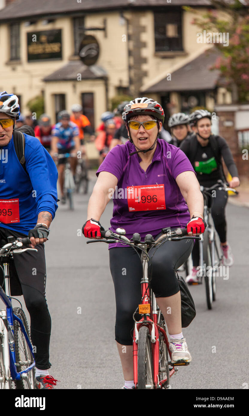 A lady cyclist going through Lindfield during the 2013 London to ...