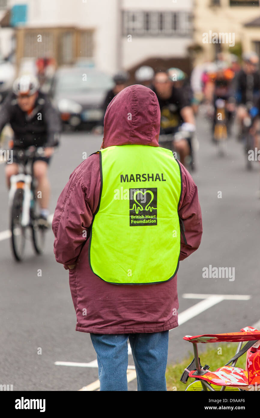 A race marshal by the famous pond in Lindfield during the 2013 London ...