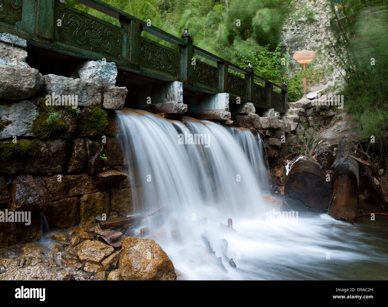 Waterfall over a stone bridge Stock Photo - Alamy