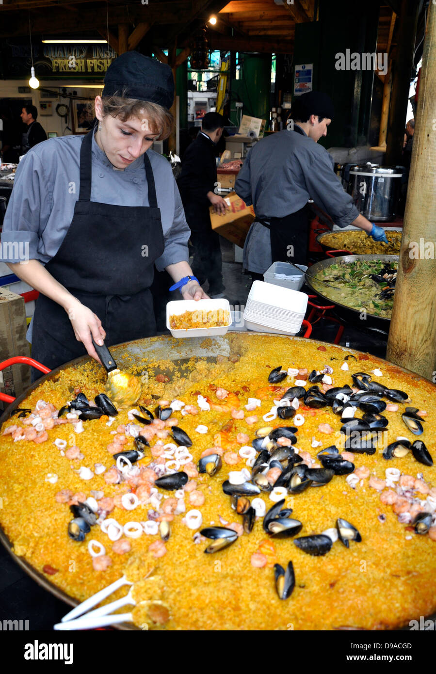 Female Chef Cooking and Serving Paella Street Food at Borough Market ...