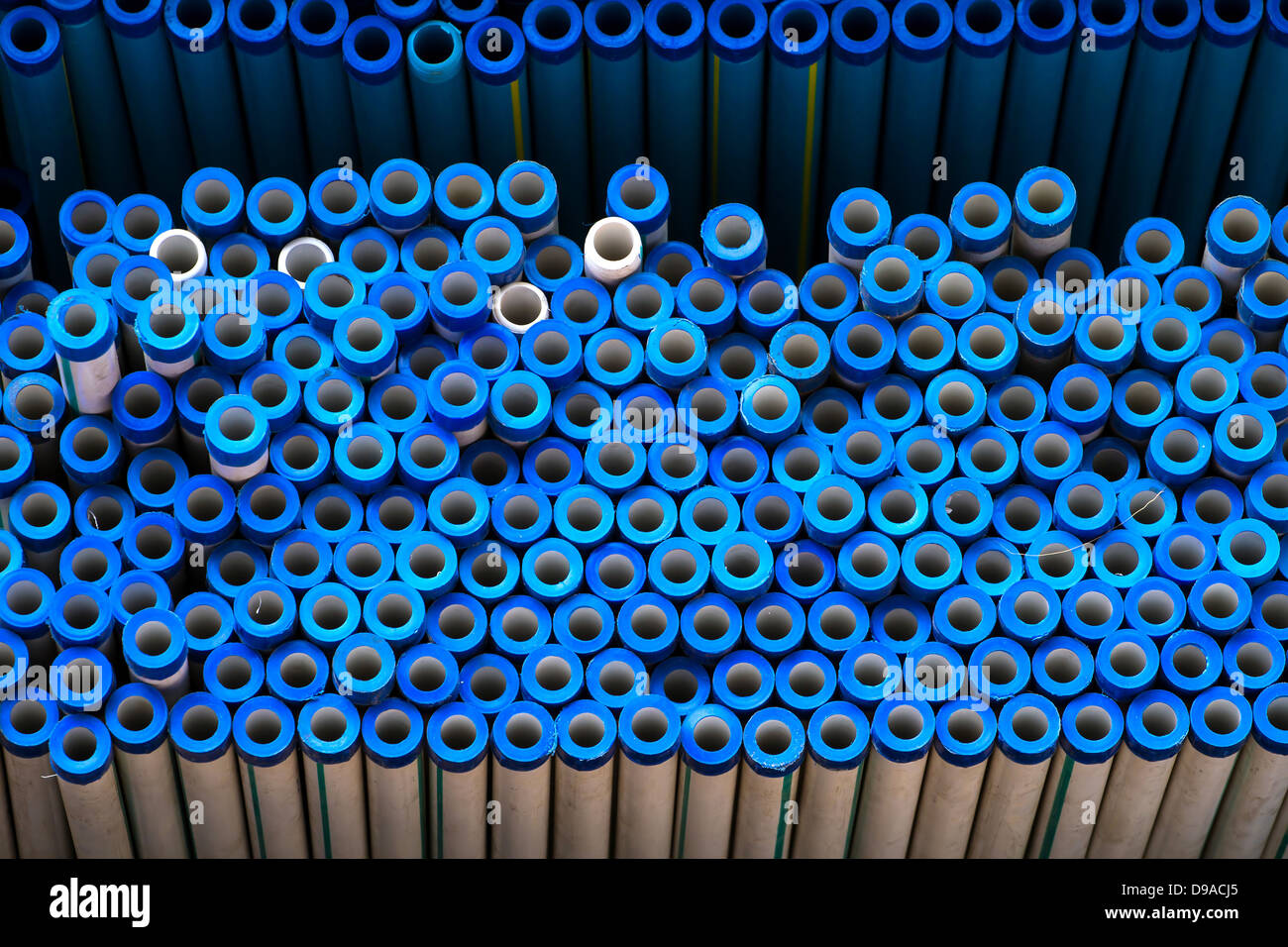 Stacked plastic pipes and tubes background Stock Photo - Alamy