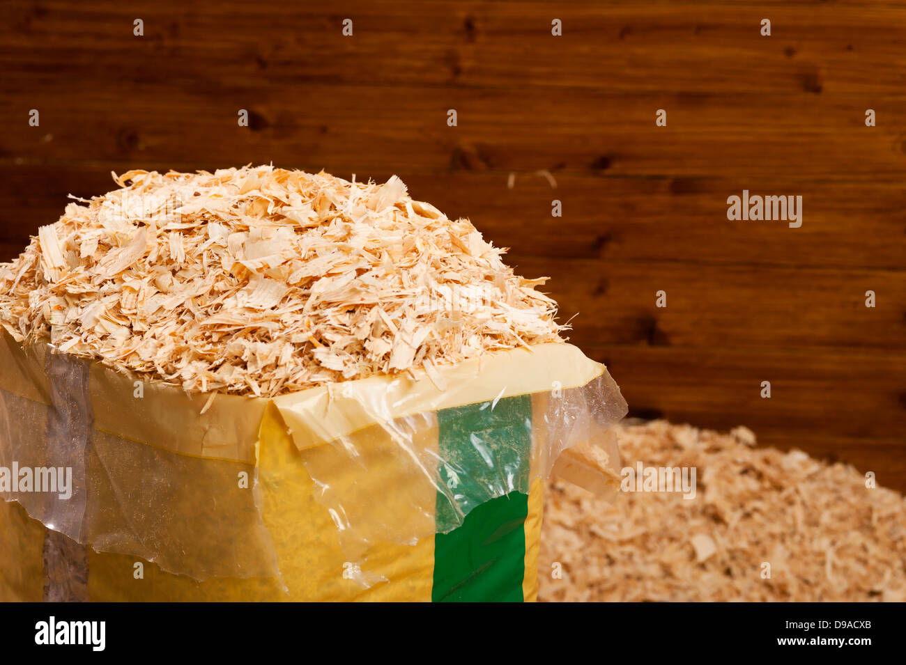 A new bale of wood shavings in horse stall for bedding Stock Photo - Alamy