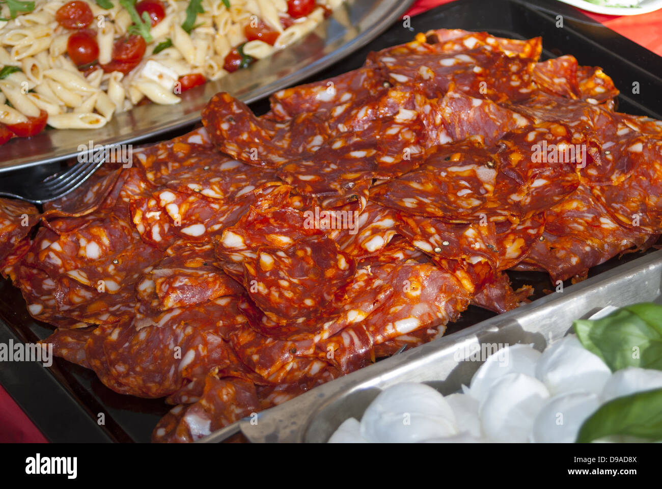 a tray of salami in a buffet of a party Stock Photo - Alamy
