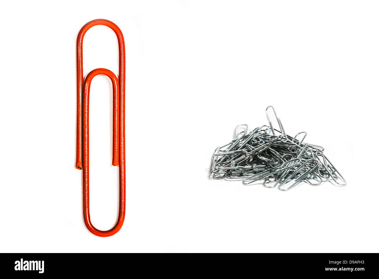 Lone red paper clip uniquely presented amongst others Stock Photo - Alamy