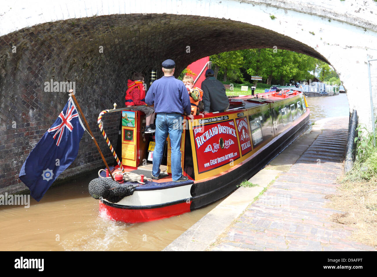 Family sailing a narrowboat on the Shropshire Union canal near Nantwich ...