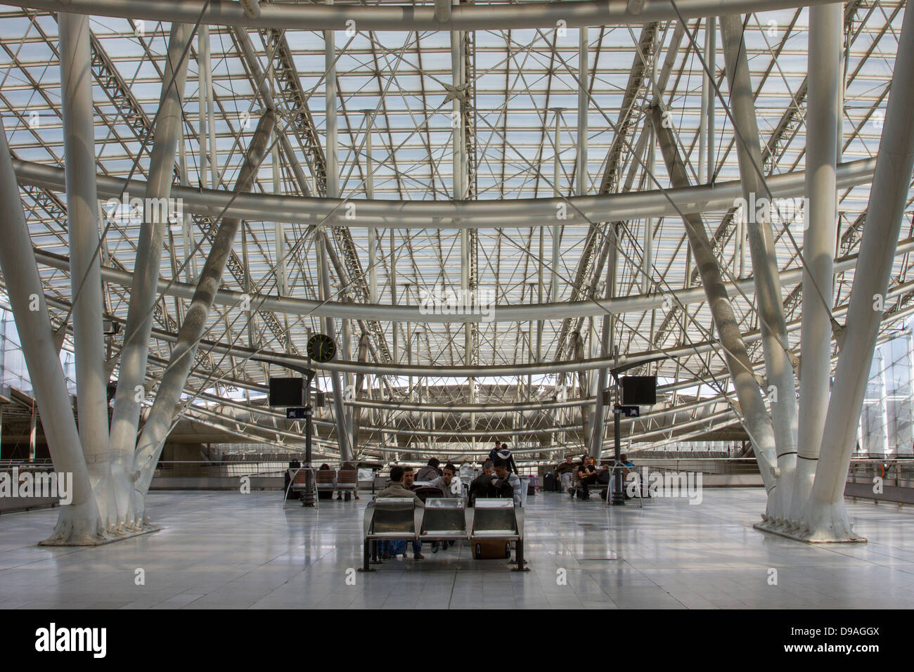 Travelers sitting in the atrium waiting area at Charles de Gaulle train ...