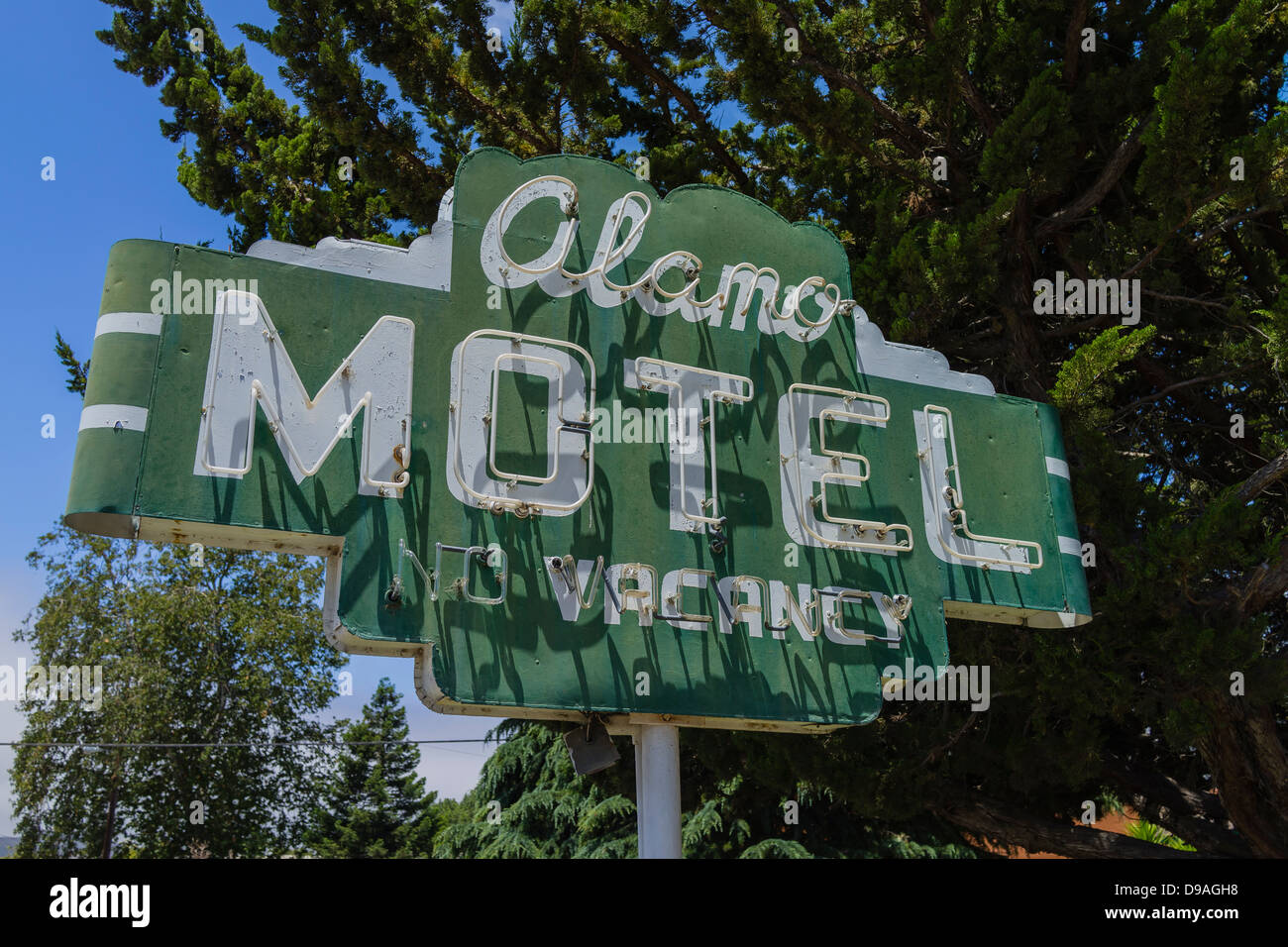 An old style, green and white, neon sign advertising the Alamo Motel in ...