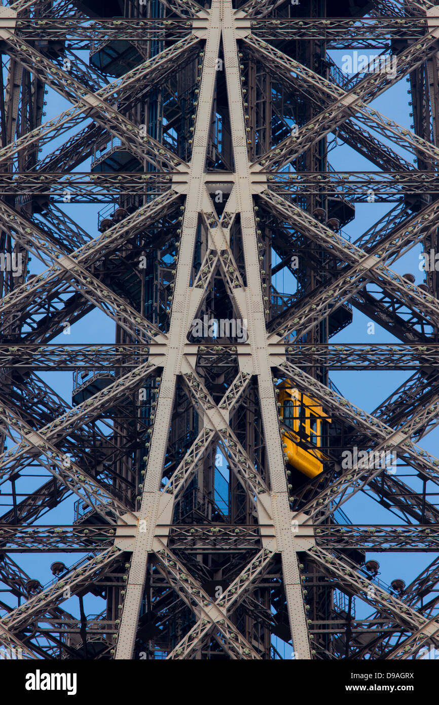 Bright orange elevator climbing through complex lattice ironwork to the ...