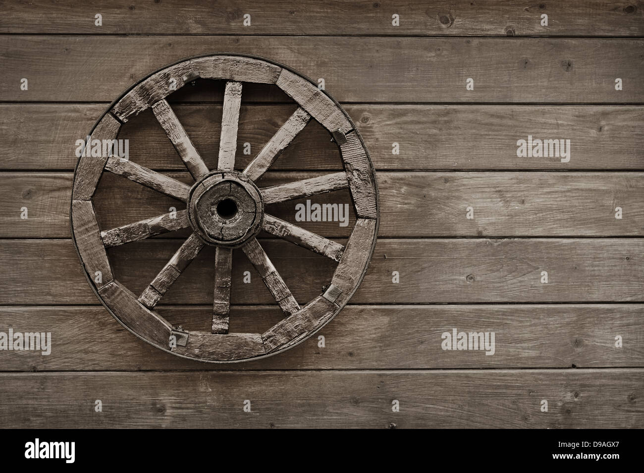 An old wooden wagon wheel on the wall of a barn Stock Photo - Alamy