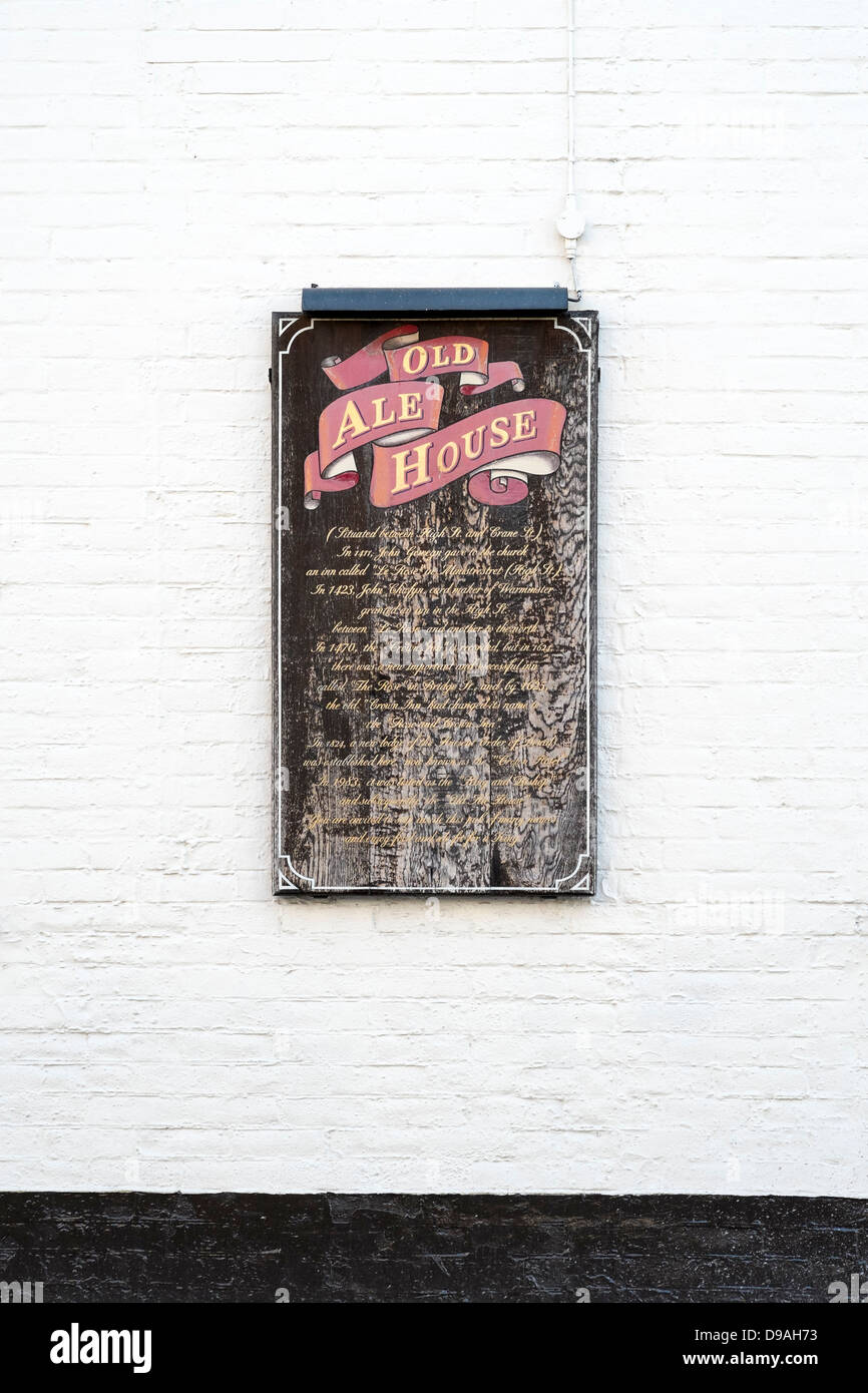 Old faded and peeling chalk blackboard mounted on the wall outside of a ...