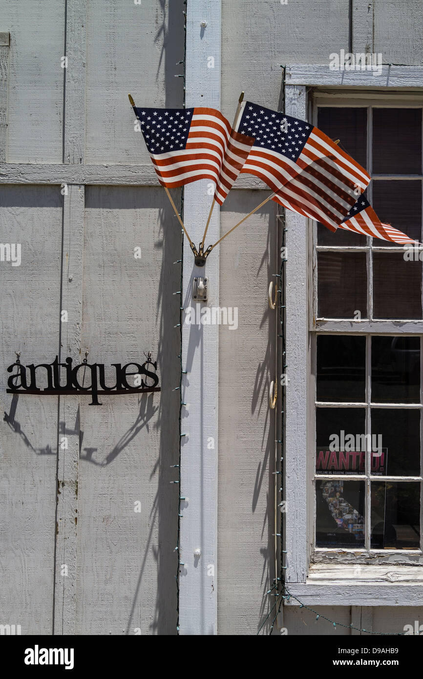 The exterior of an antique store located in an old wooden building with ...