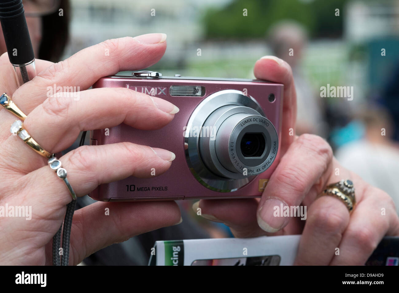 Lady's hands holding a pink Lumix compact digital camera Stock Photo ...