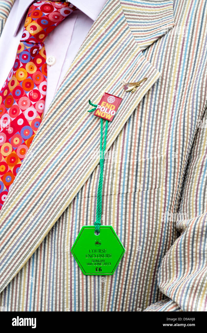 Horse racing track pass hanging from a gentleman's lapel. Also brightly ...