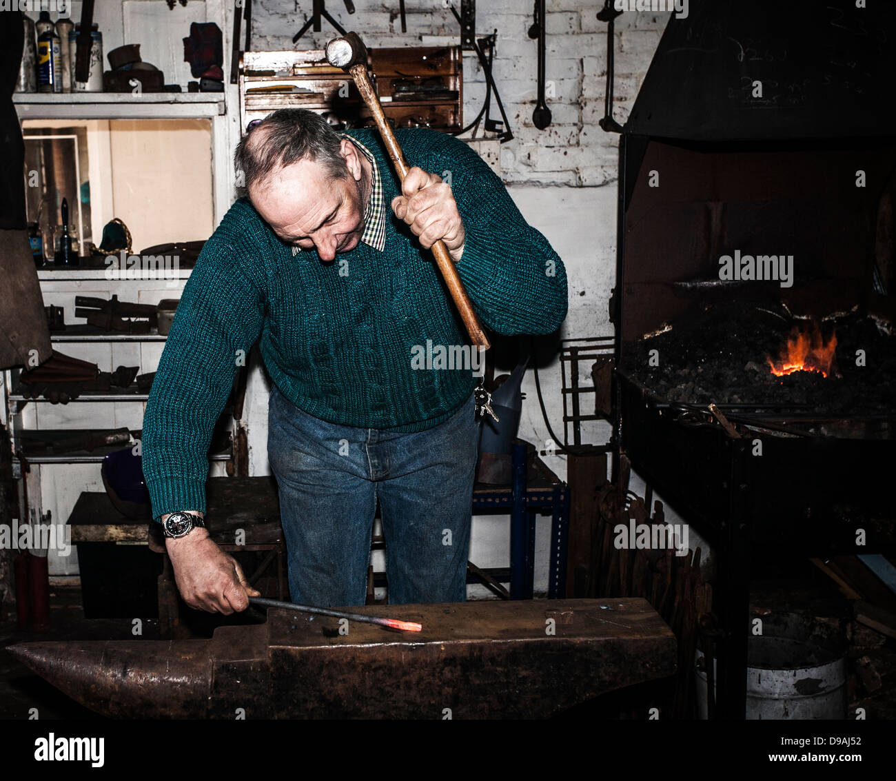 Blacksmith working at an anvil Stock Photo - Alamy
