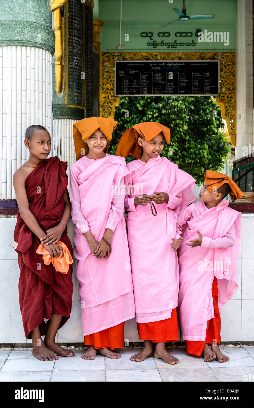 Young Buddhist nuns and monk at Shwedagon Pagoda or Great Dagon Pagoda ...