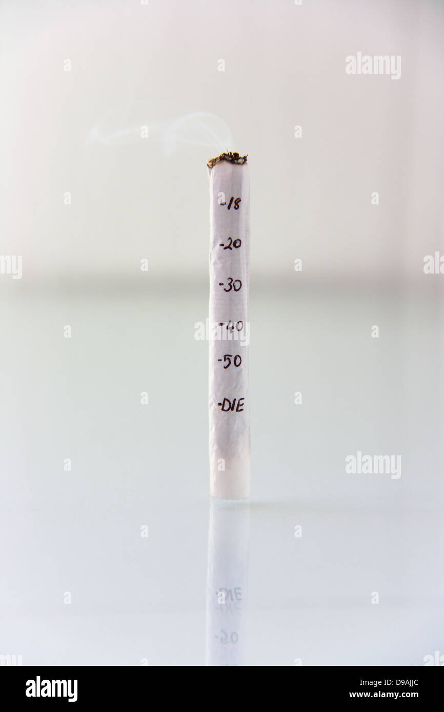 hand made cigarette burning in front of white background Stock Photo ...