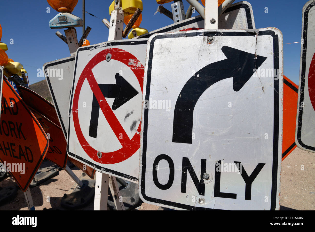 Traffic control signs await placement at a road construction site ...