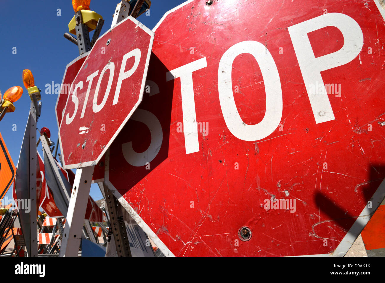 Traffic control signs await placement at a road construction site ...