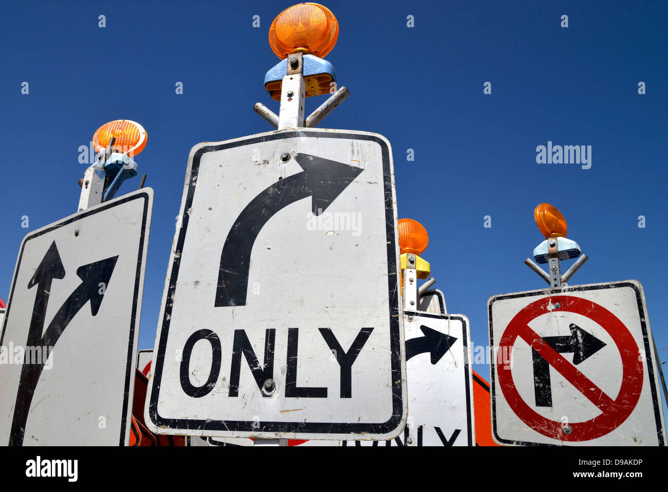 Traffic control signs await placement at a road construction site ...