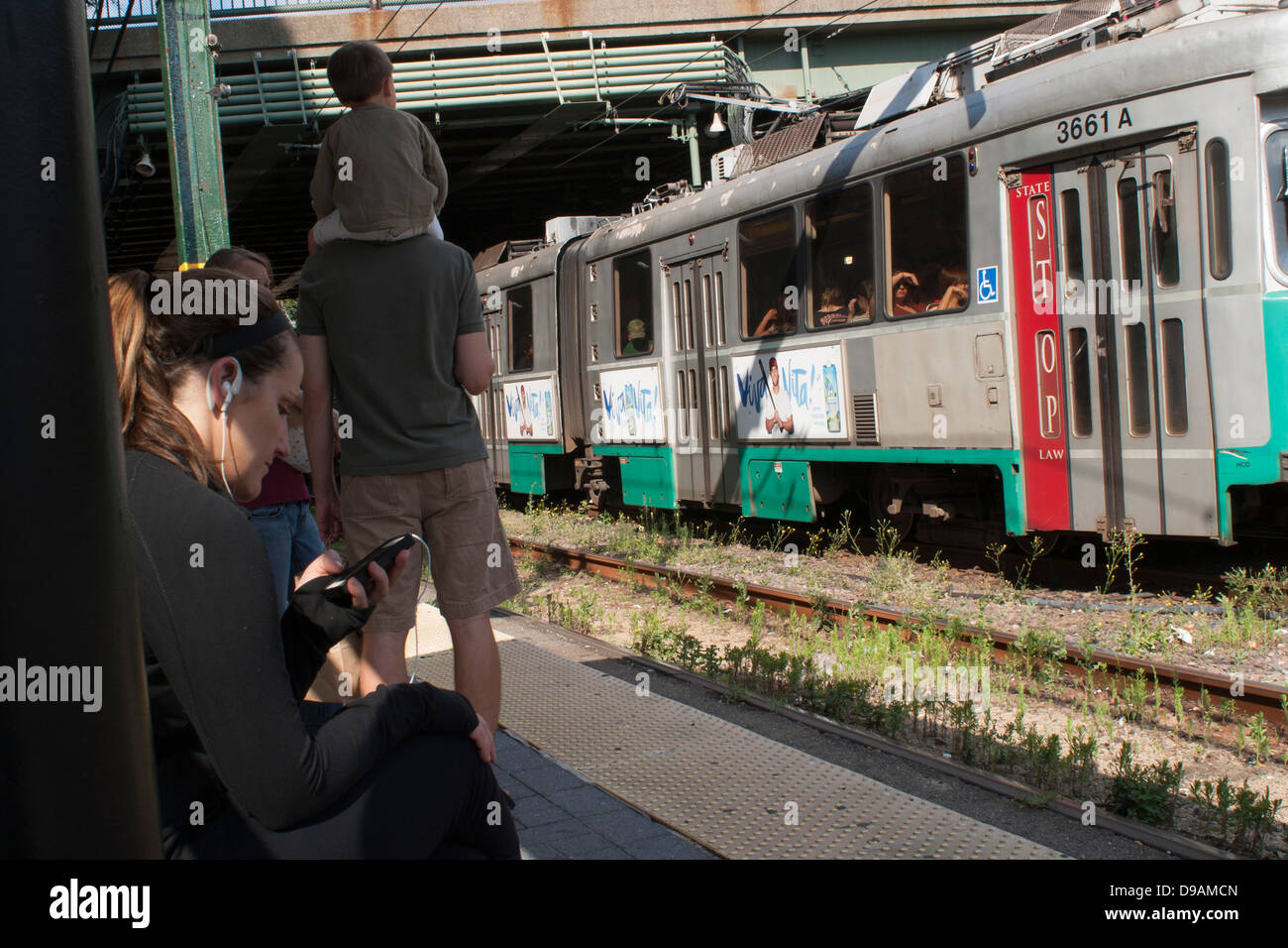 Passengers wait for outbound trains at the Fenway train stop on the ...