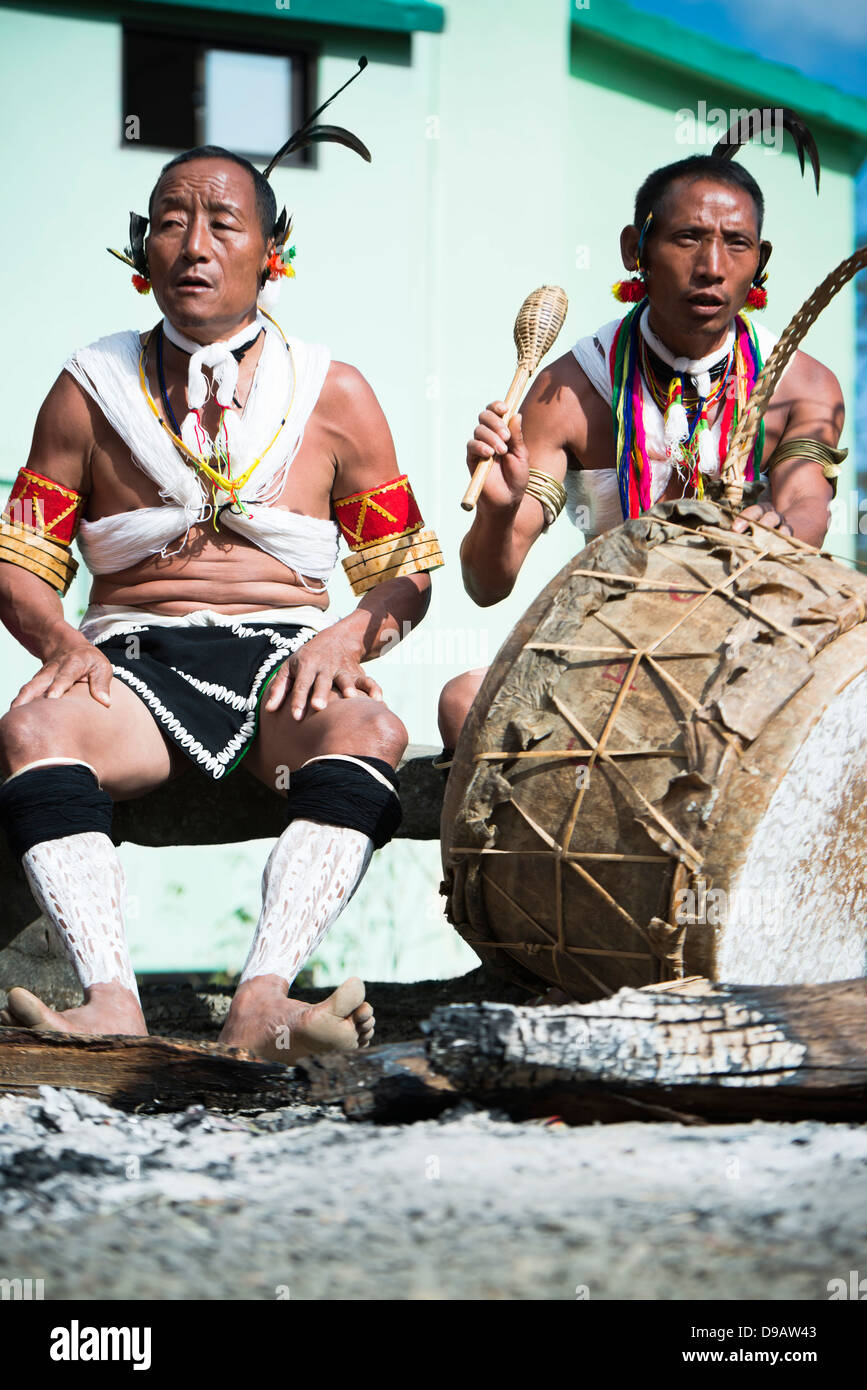 Naga tribal men in traditional outfit playing drum, Hornbill Festival ...