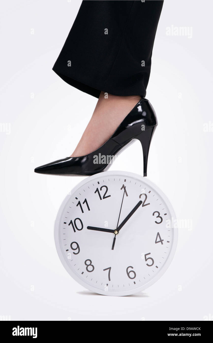 Oriental business lady on a clock Stock Photo - Alamy