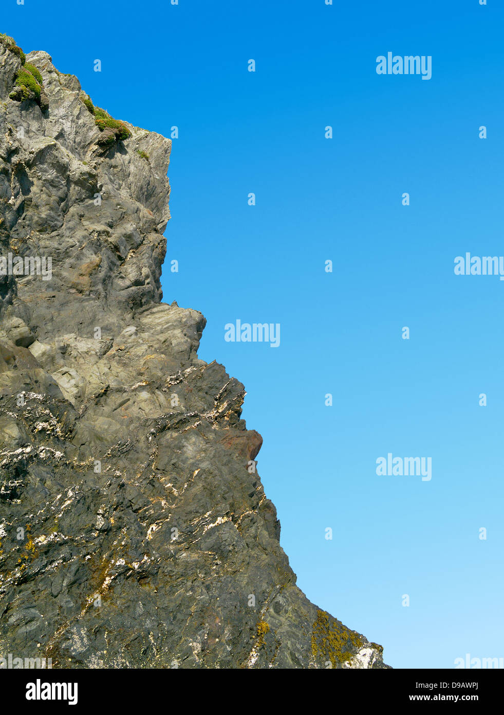Jagged granite rock cliff edge and blue sky Stock Photo - Alamy