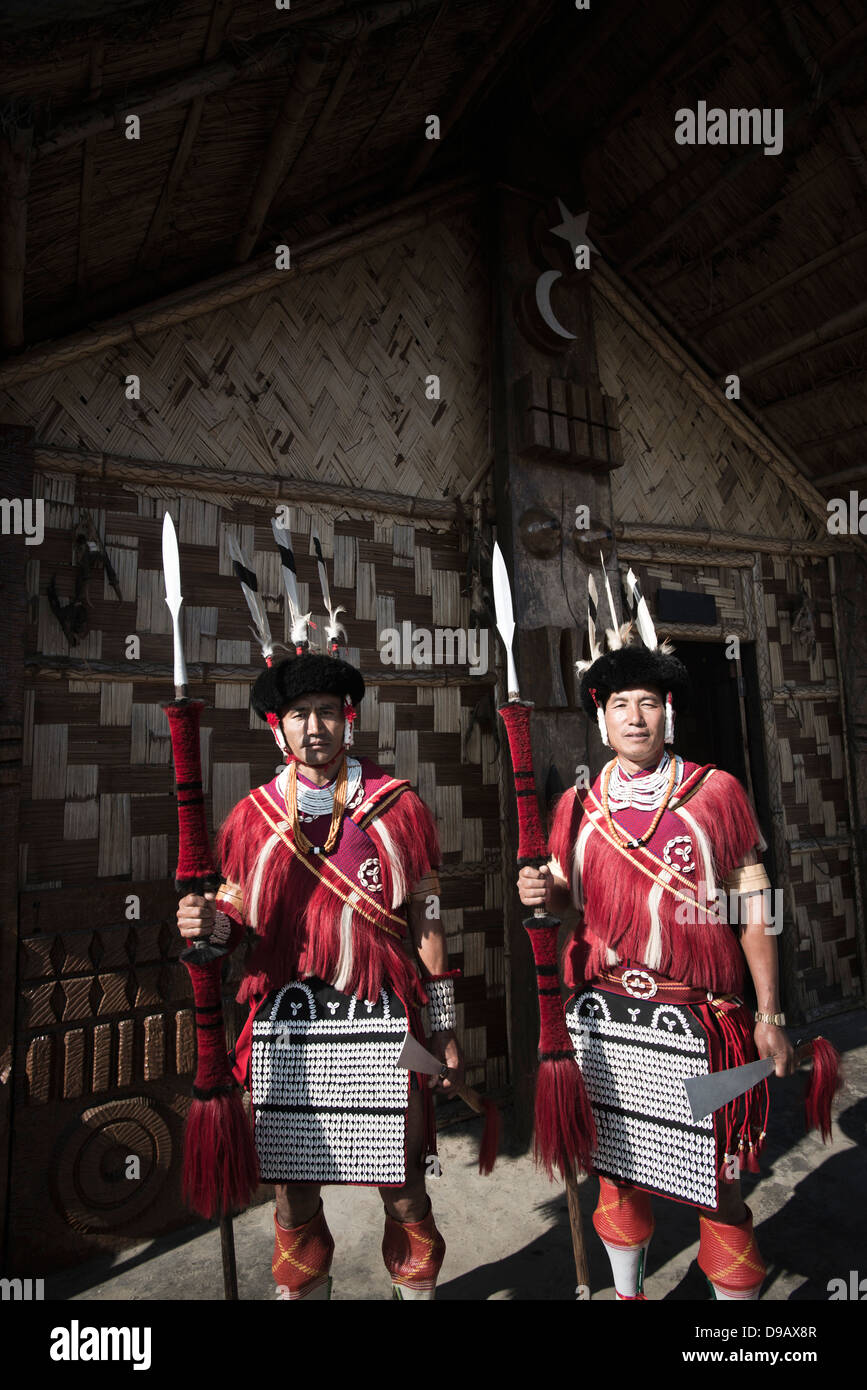 Naga tribal warriors standing with spears outside a hut, Hornbill ...