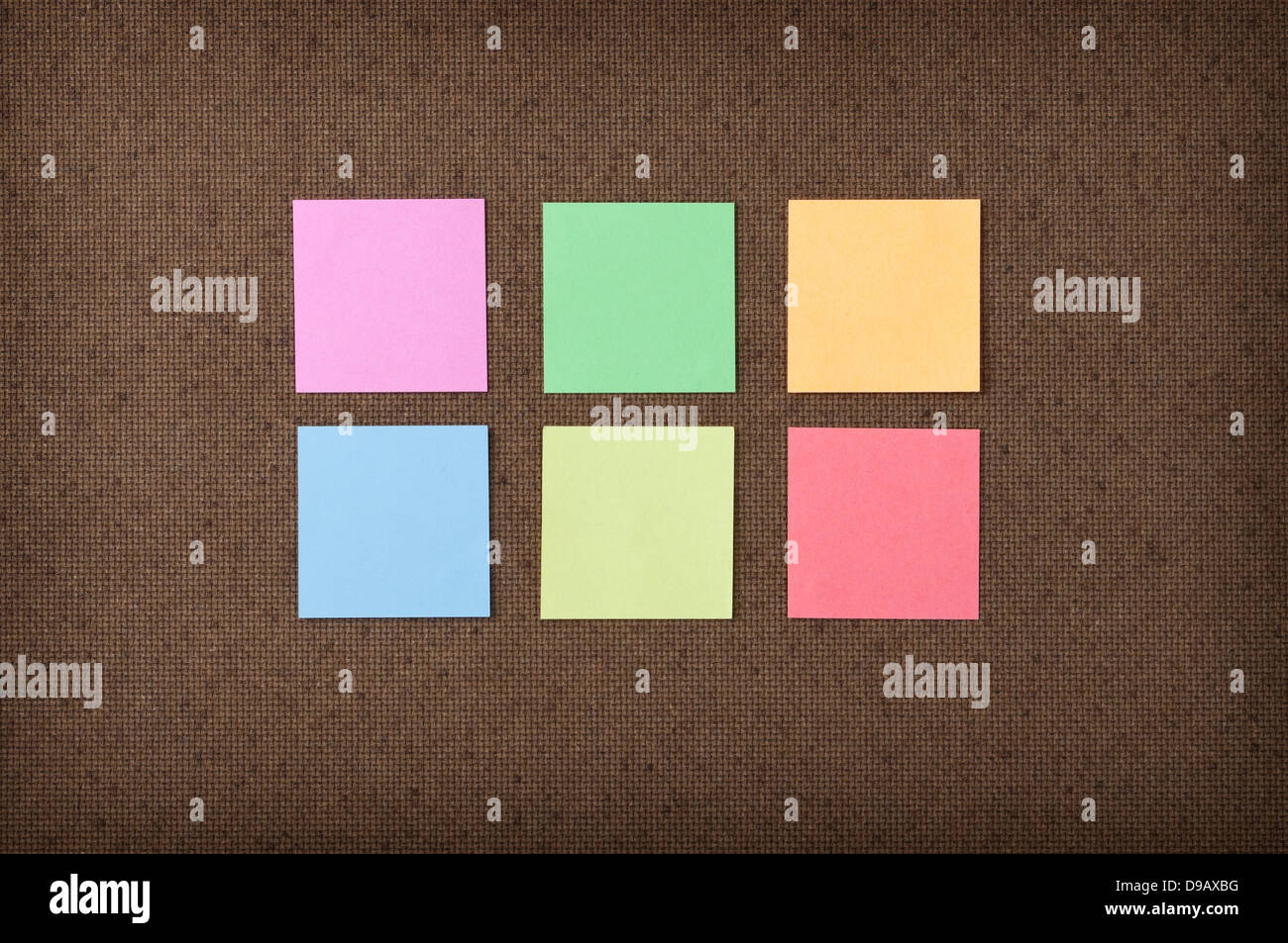 Sticky notes on fiberboard background Stock Photo - Alamy