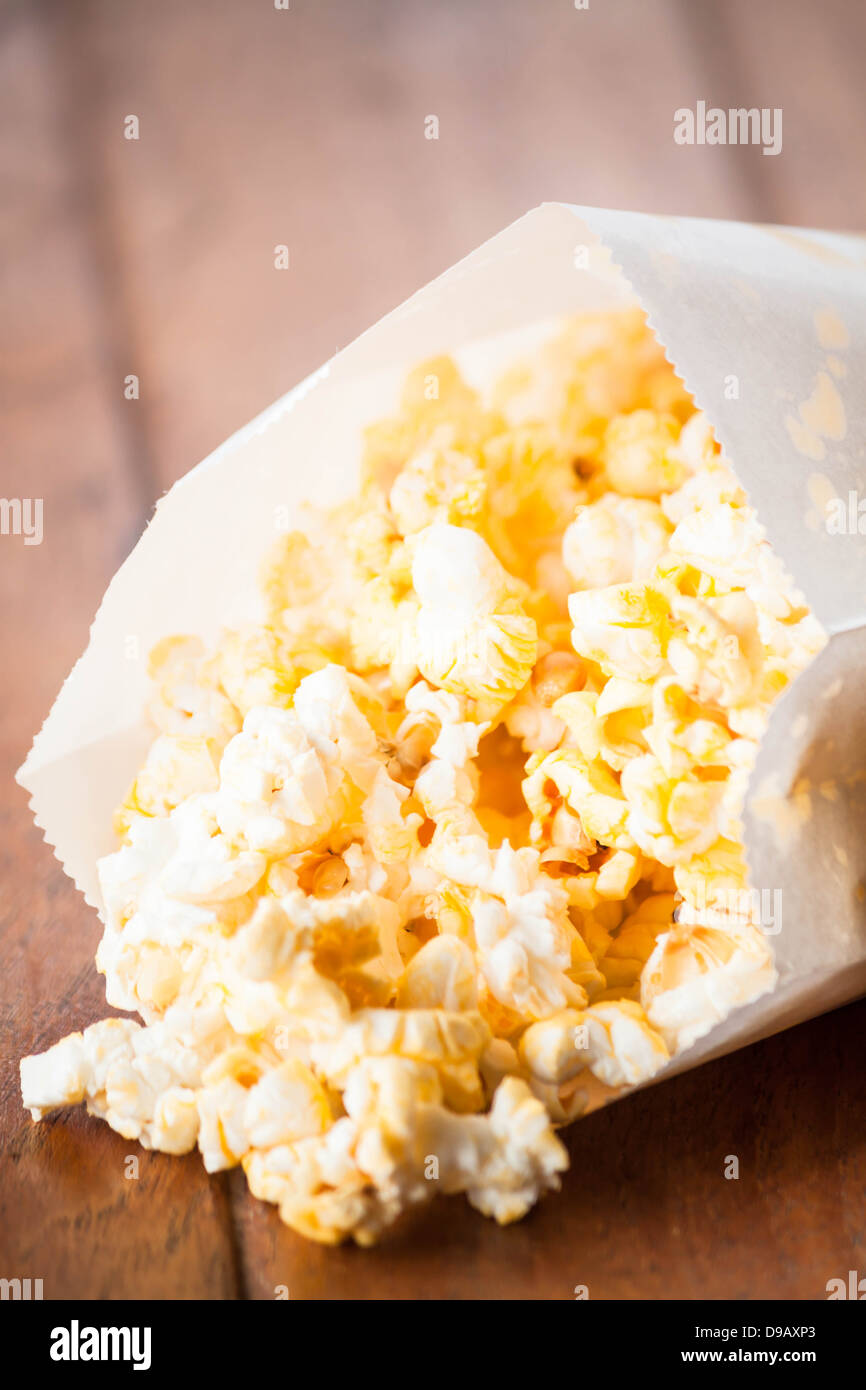 Fresh popcorn in paper bag on wood table Stock Photo - Alamy
