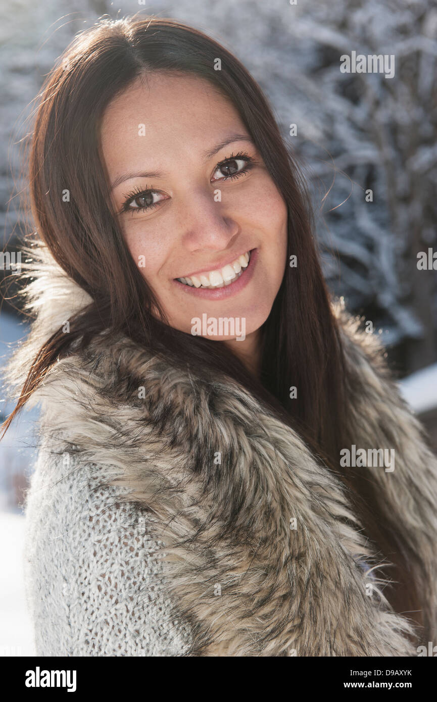 Austria, Salzburg, Portrait of young woman in snow, smiling Stock Photo ...