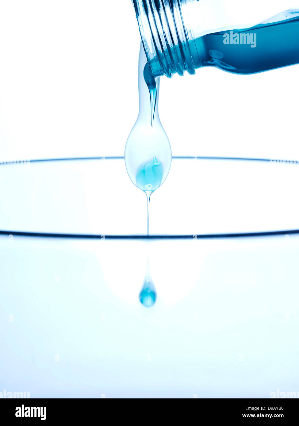 Liquid pouring in laboratory jar, close up Stock Photo - Alamy