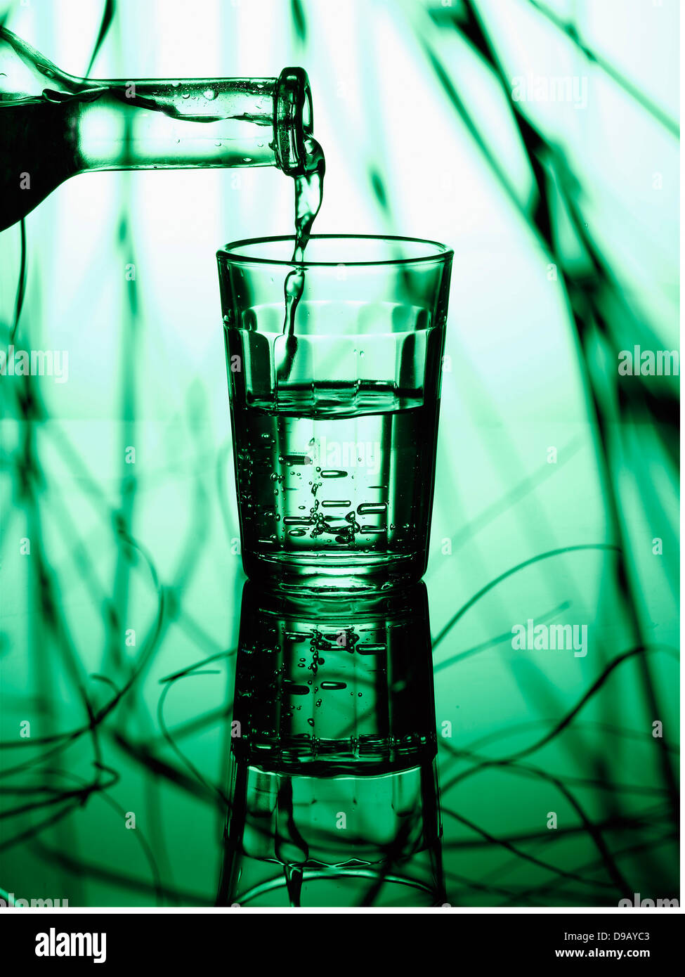 Bottle pouring drink in glass, close up Stock Photo - Alamy