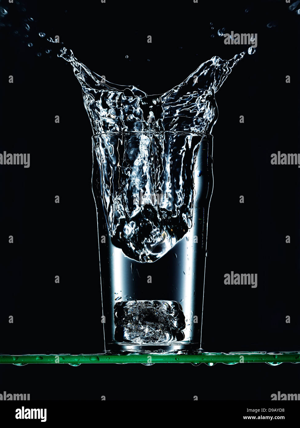 Splashing water from glass Stock Photo - Alamy