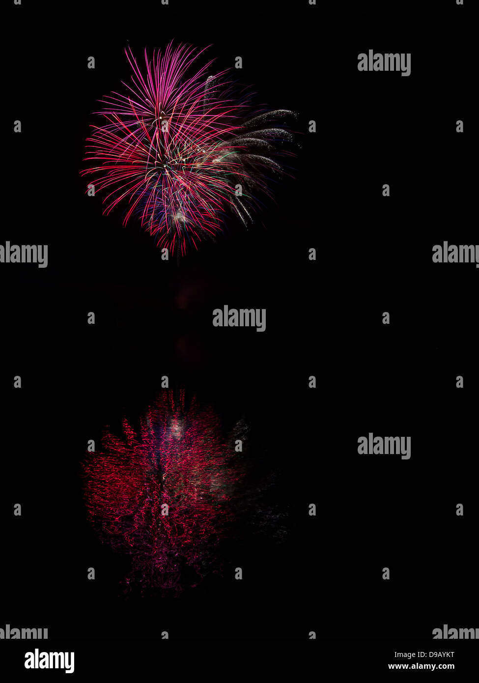 Germany, Fireworks exploding in sky at night with reflection Stock ...