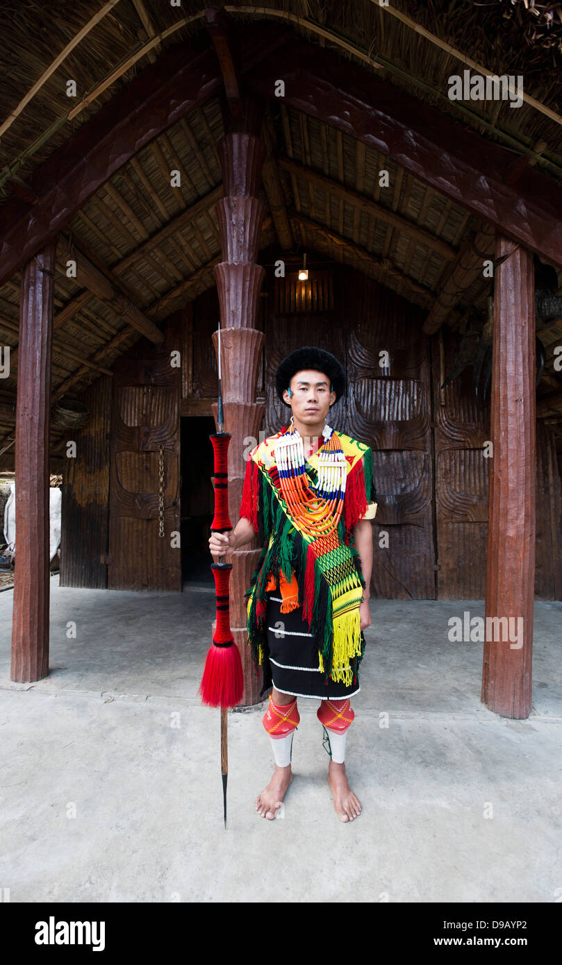 Naga tribal warrior in traditional outfit standing with spear in front ...