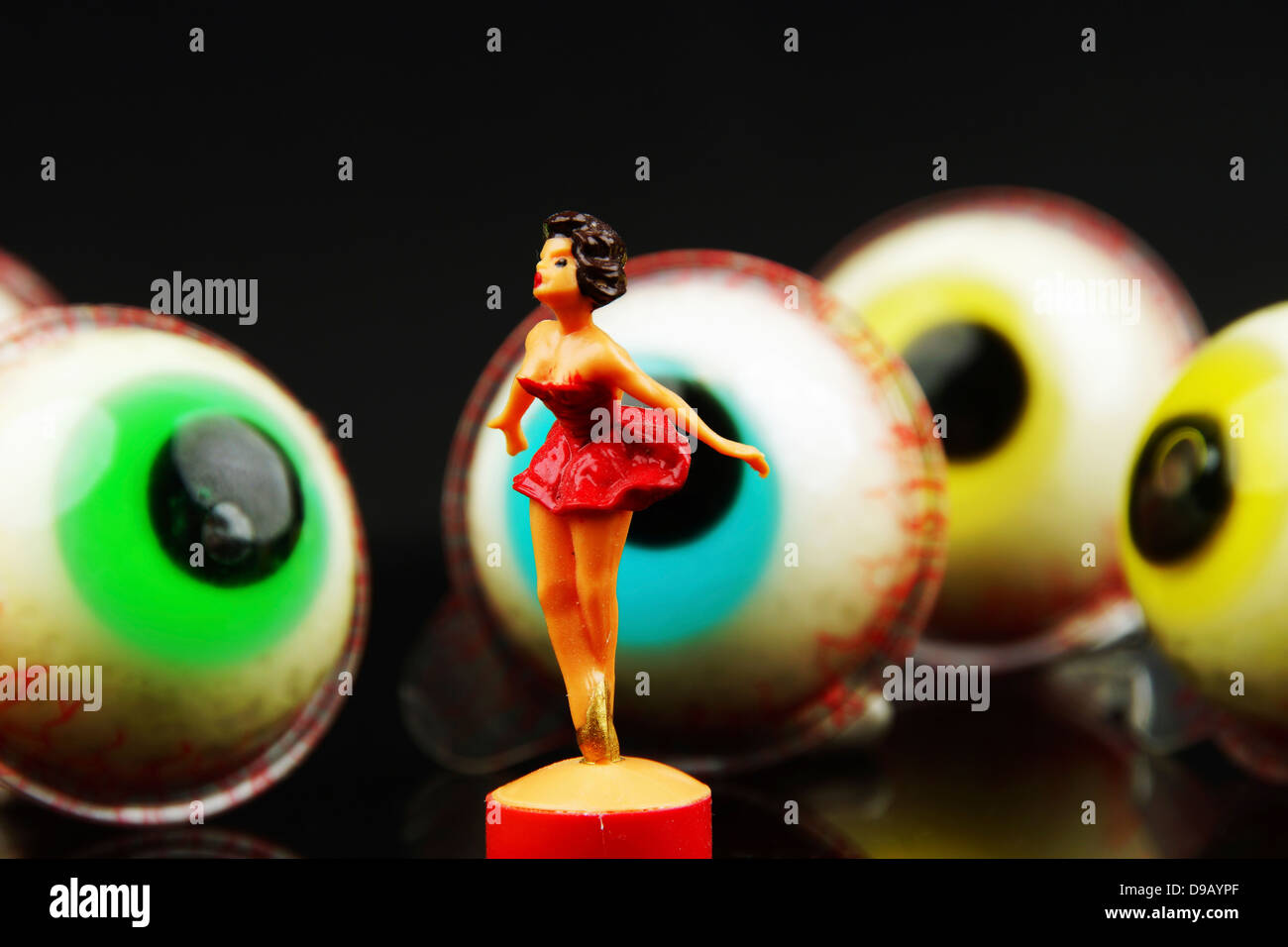 Dancing figurine in casting situation with candy eyeballs in background ...