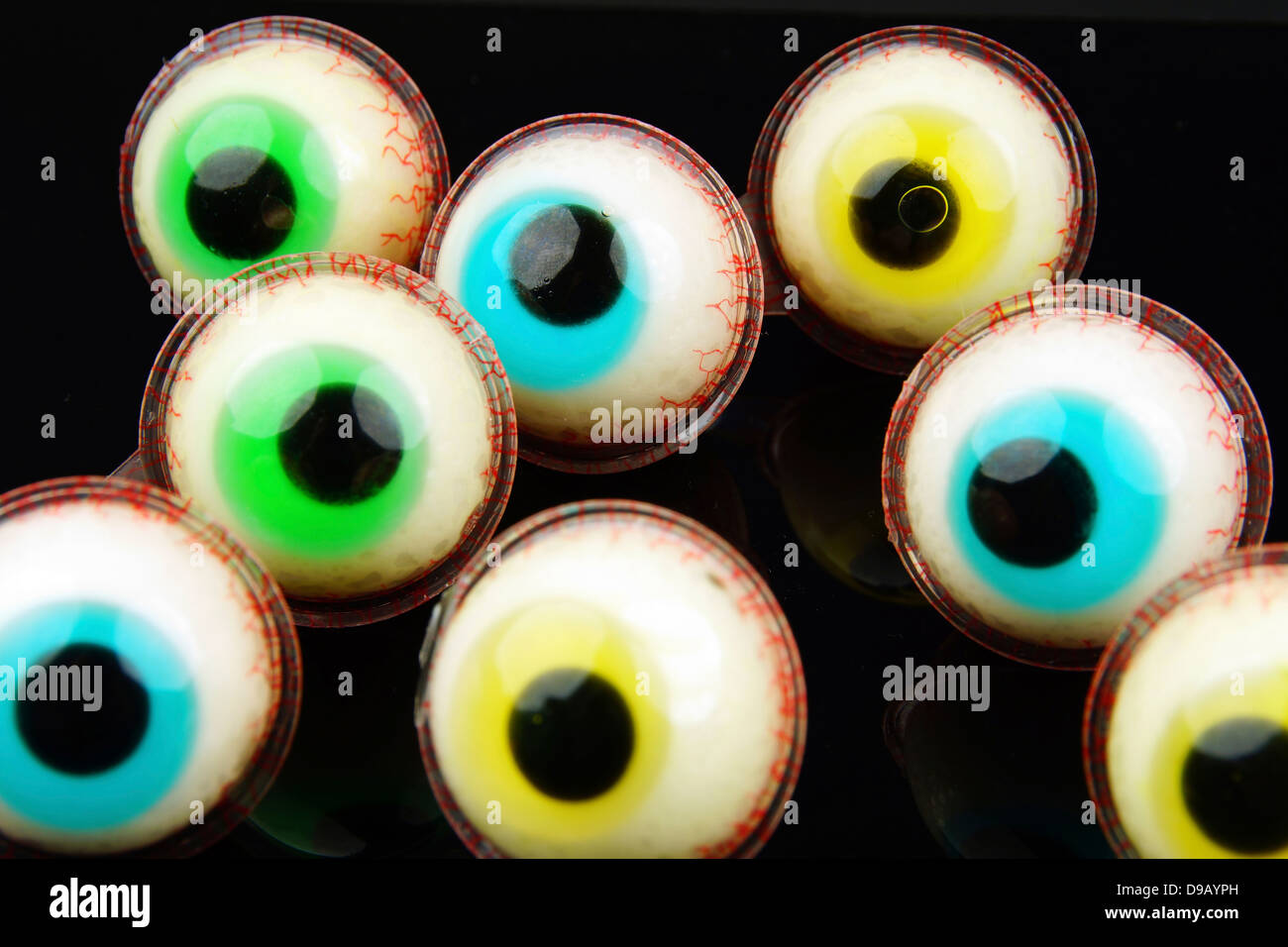 Assortment of colorful candy eyeballs on black background Stock Photo ...