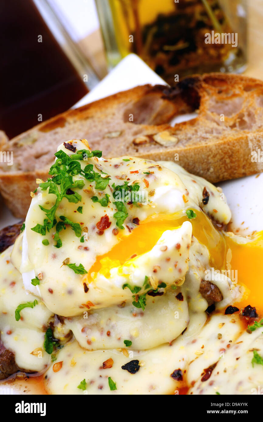 Egg benedict on plate, close up Stock Photo - Alamy