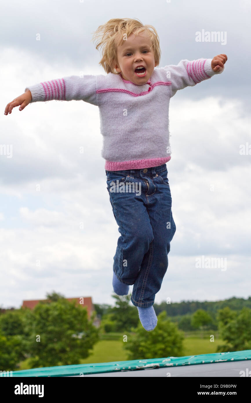 Germany, Kiel, Girl jumping on trampoline Stock Photo - Alamy