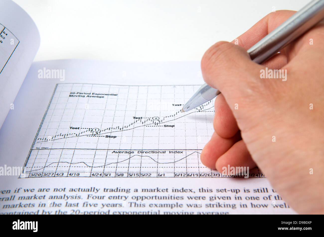 Hand with pen pointing on stock chart Stock Photo - Alamy