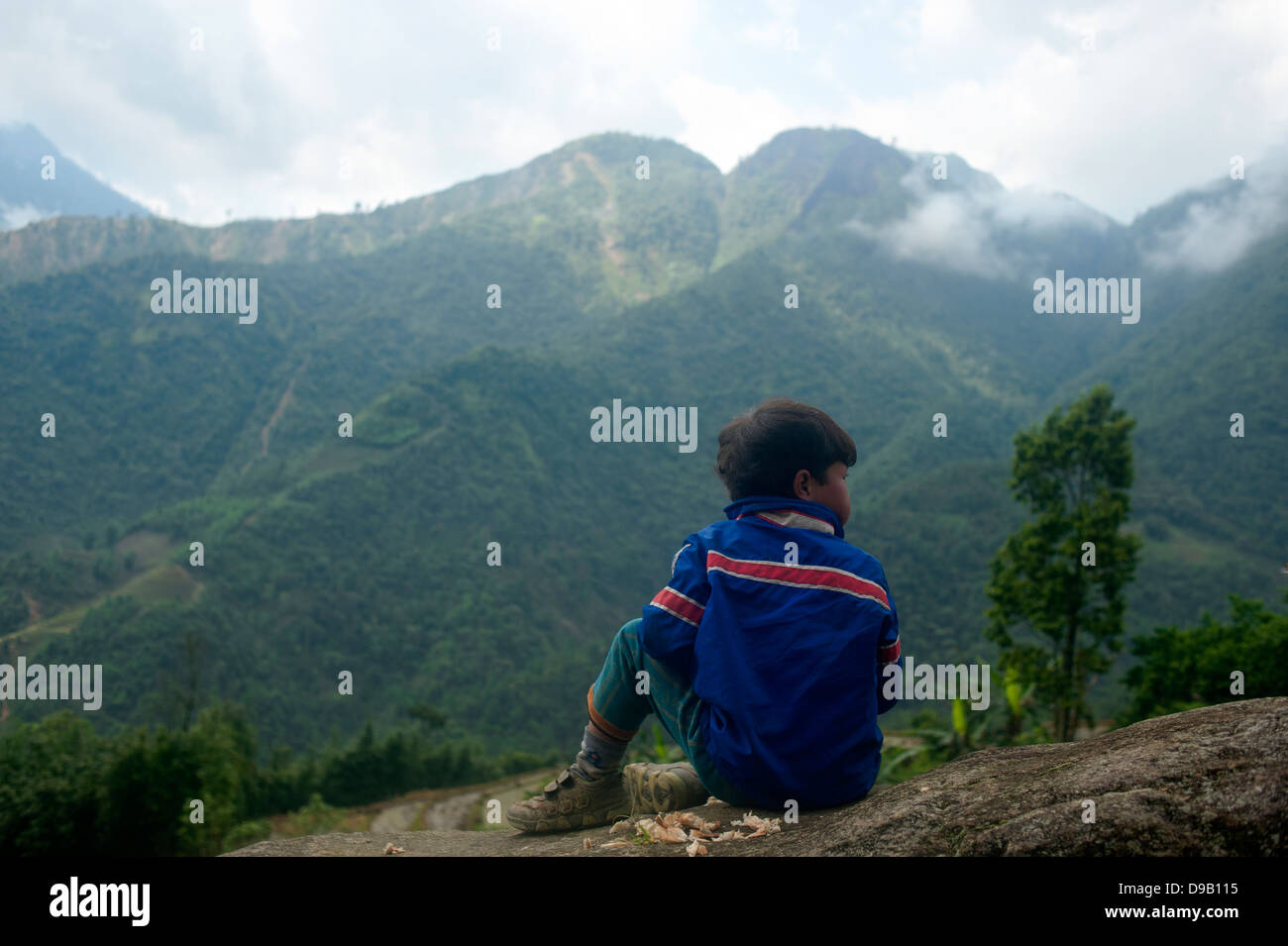 Boy sitting on rock hi-res stock photography and images - Alamy