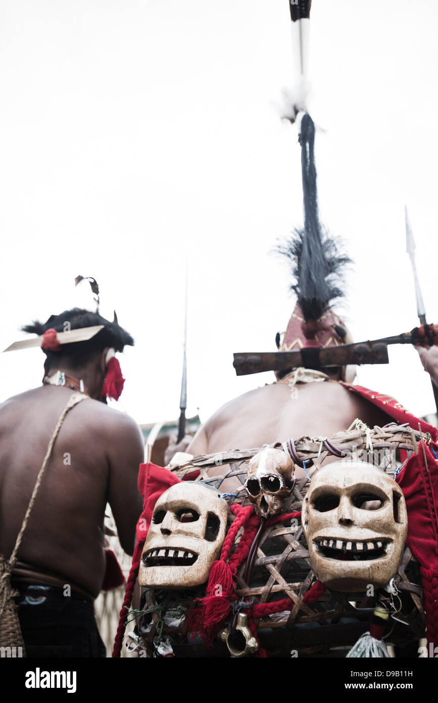 Rear view of two Naga tribal warriors in traditional outfit, Hornbill ...