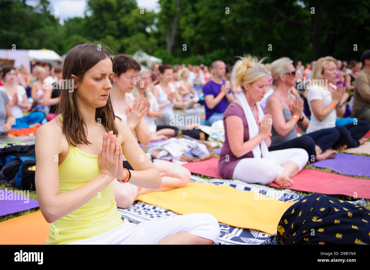 Participants moves at the 9th Berlin Yoga Festival at Wannsee in Berlin ...