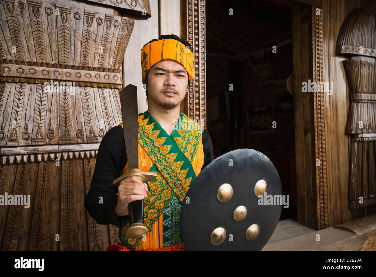 Naga tribal man standing with sword and shield, Hornbill Festival ...