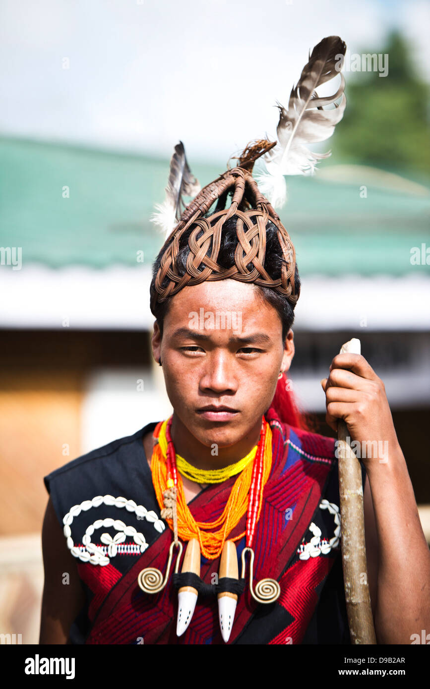 Naga tribesman in traditional outfit holding a stick during the annual ...