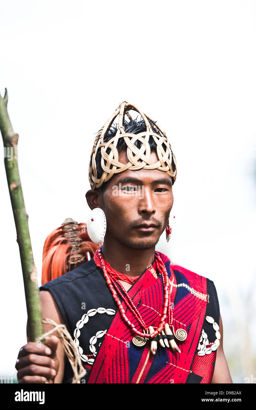 Naga tribesman in traditional outfit holding a stick during the annual ...