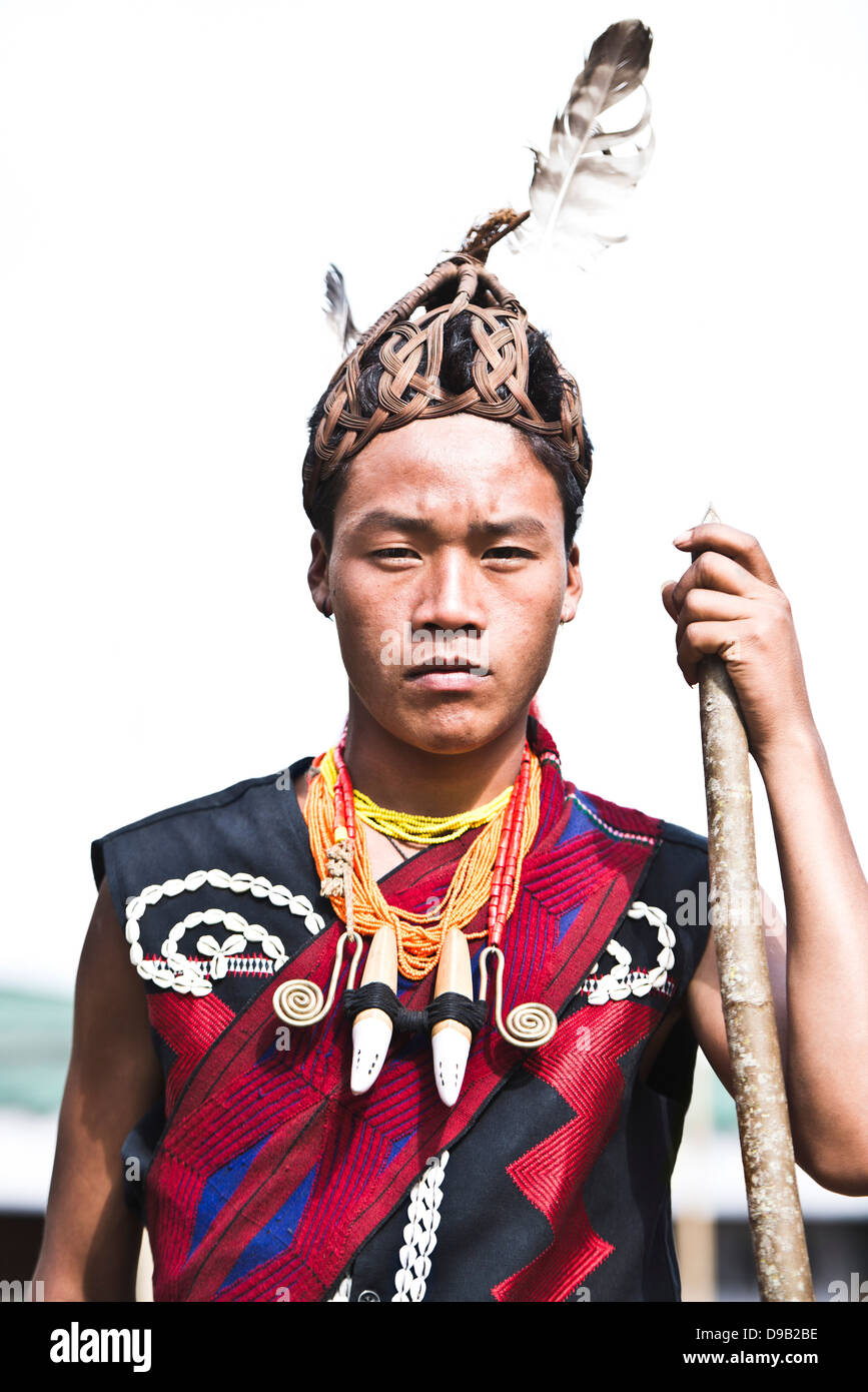 Naga tribesman in traditional outfit holding a stick during the annual ...
