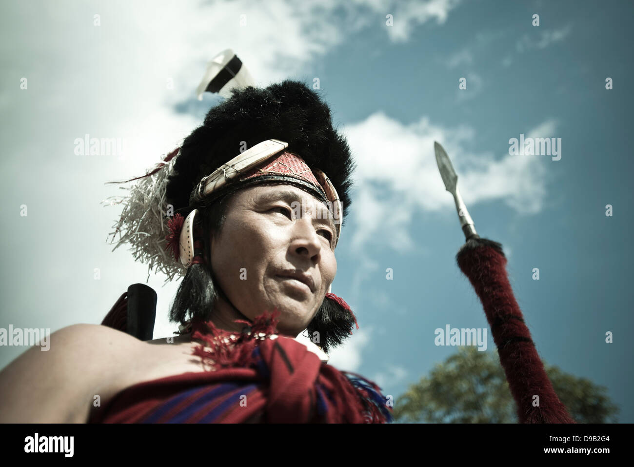 Naga tribesman in traditional outfit holding a spear during the annual ...